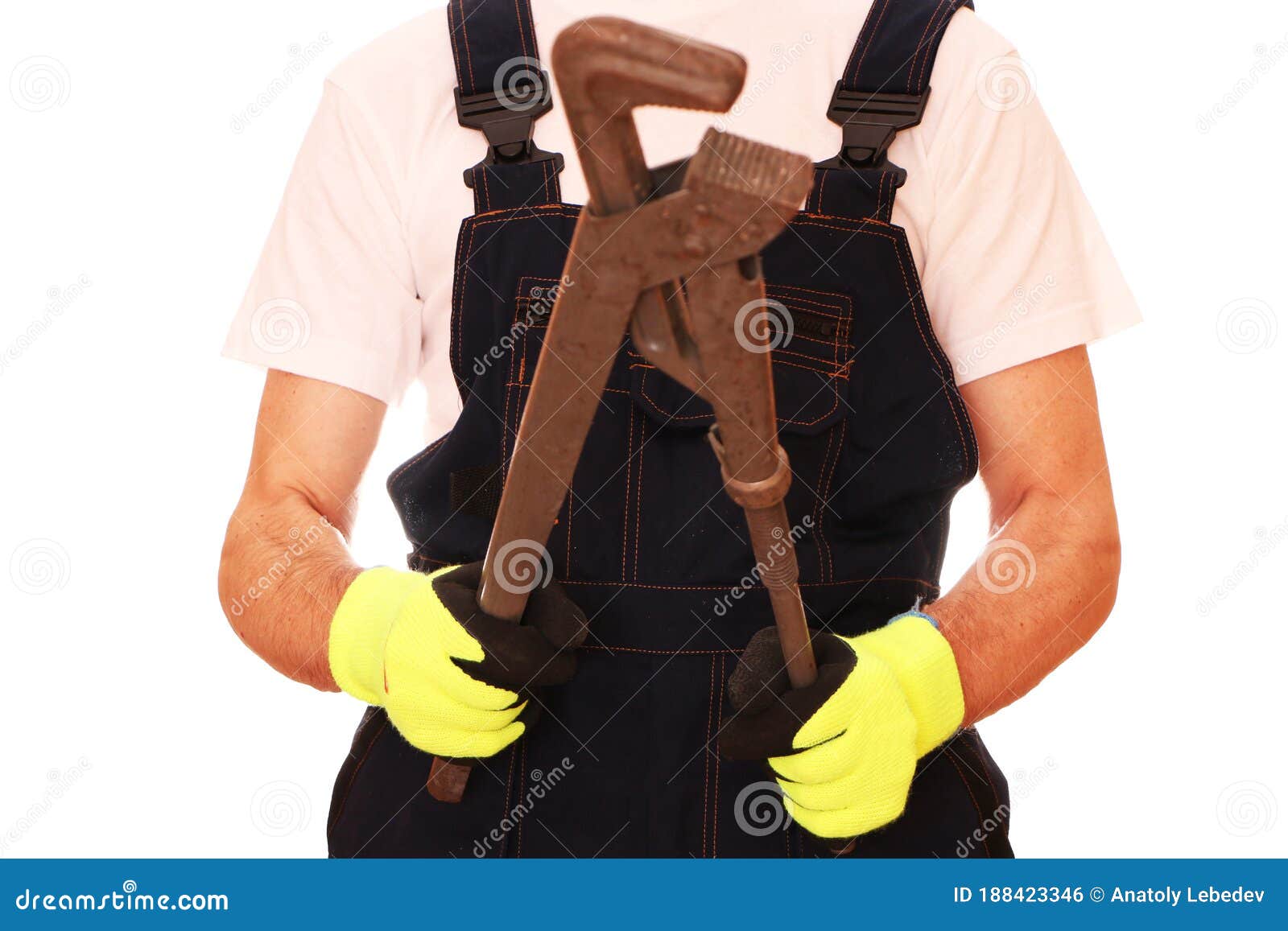 The Builder is Holding a Large Adjustable Spanner in His Hands. the ...