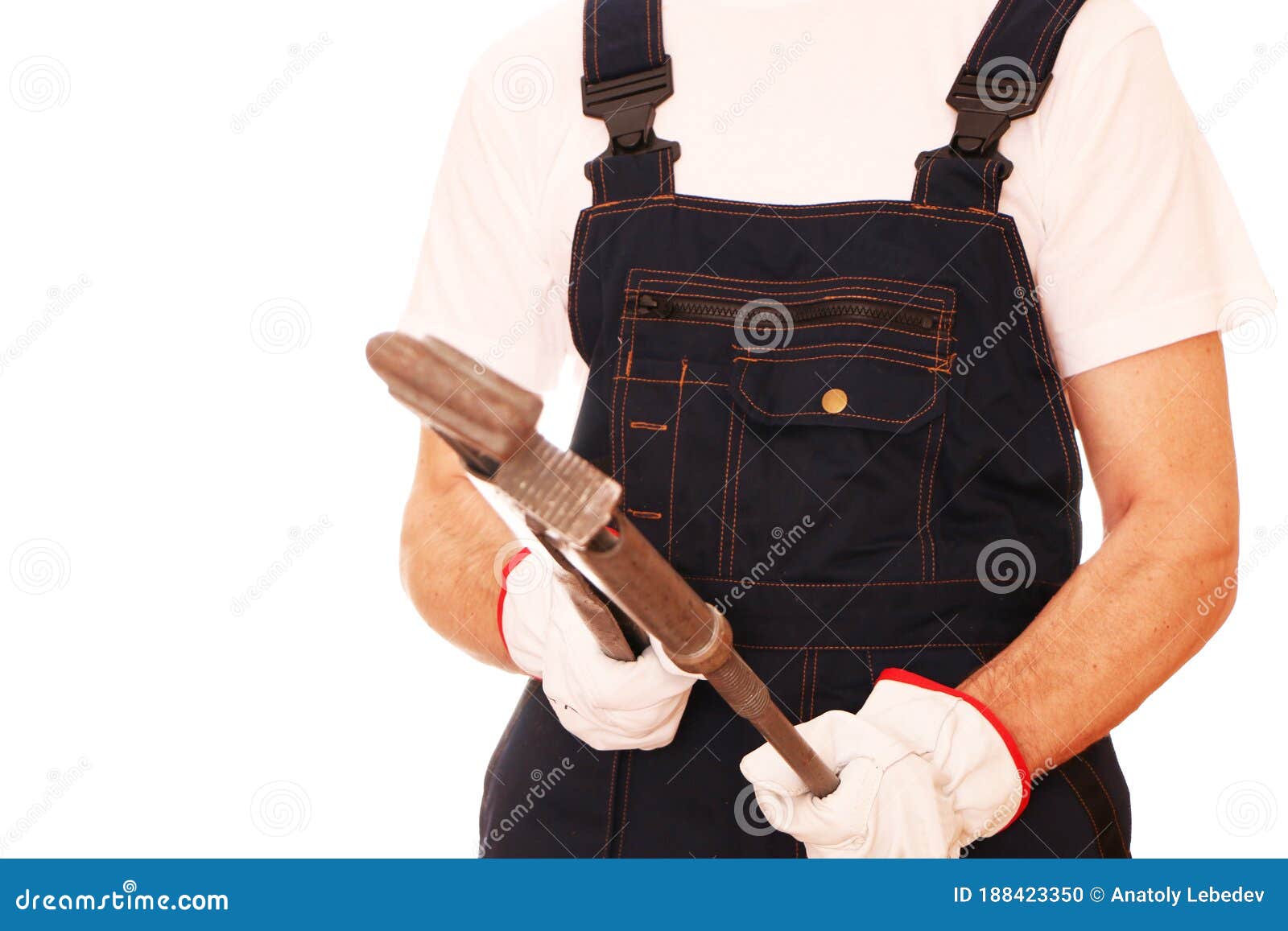 The Builder is Holding a Large Adjustable Spanner in His Hands. the ...