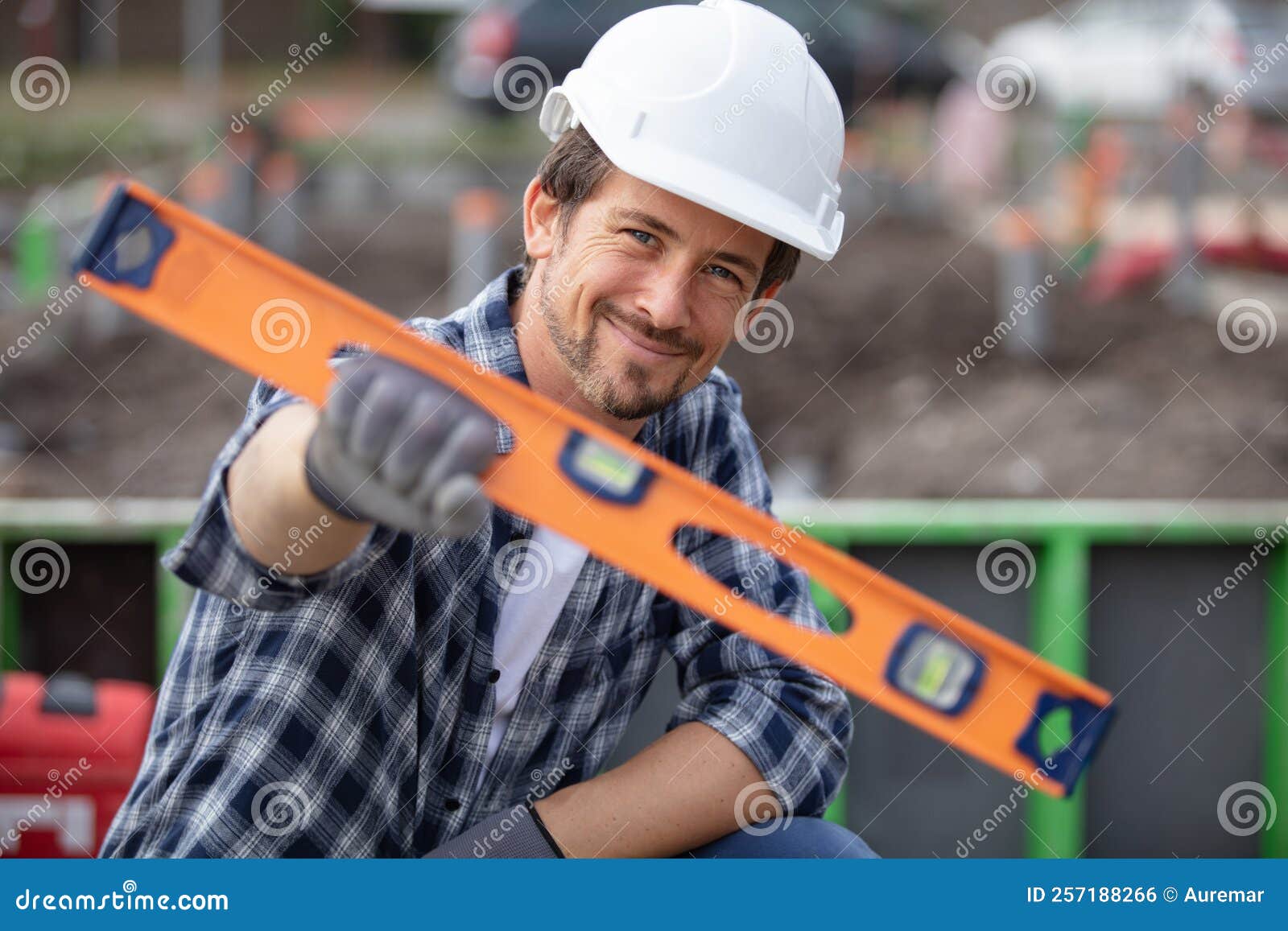 Builder Holding Spirit Level at Construction Site Stock Photo - Image ...