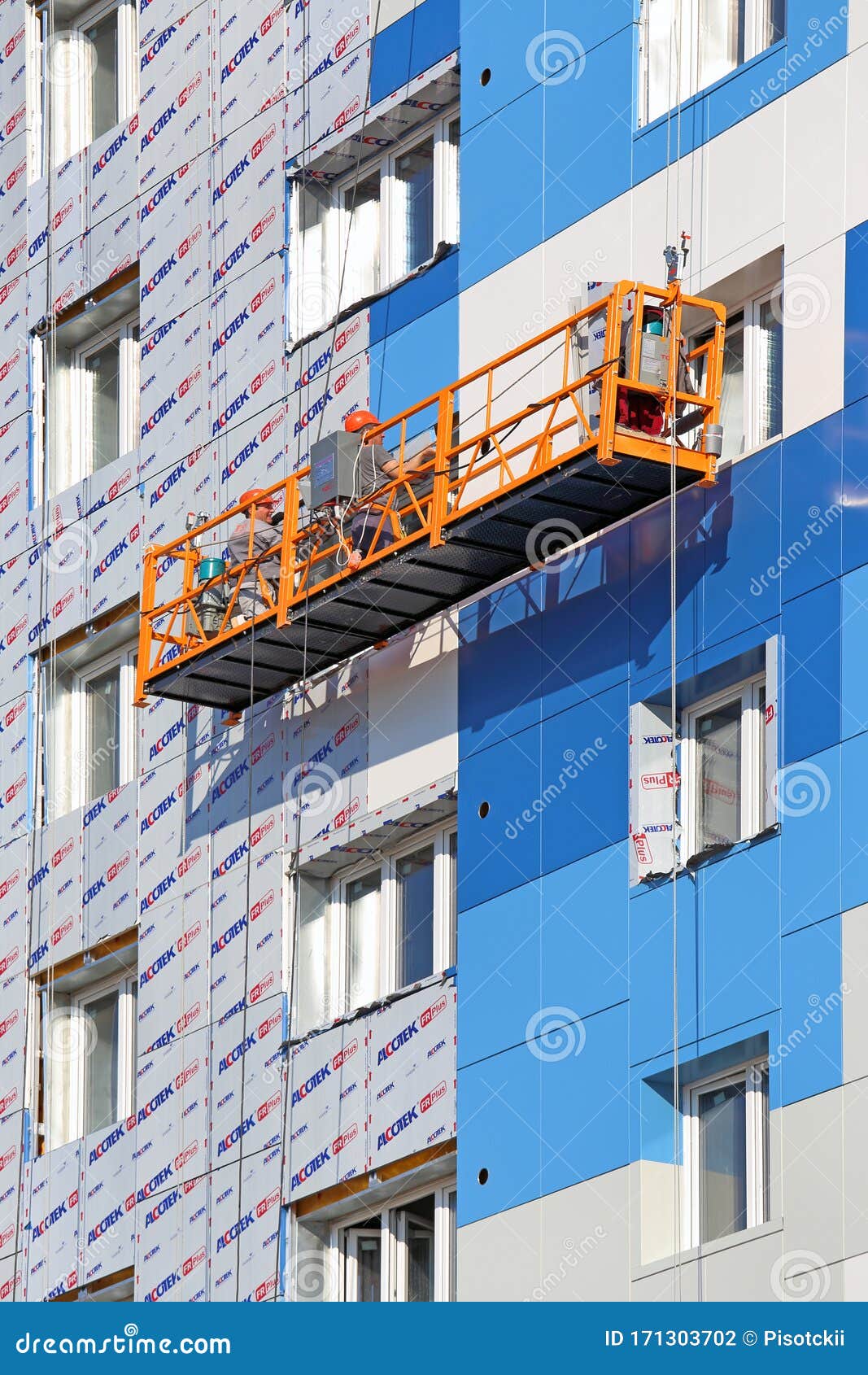 The Builder is Installing the Facade Panels of a Multi-storey Building ...