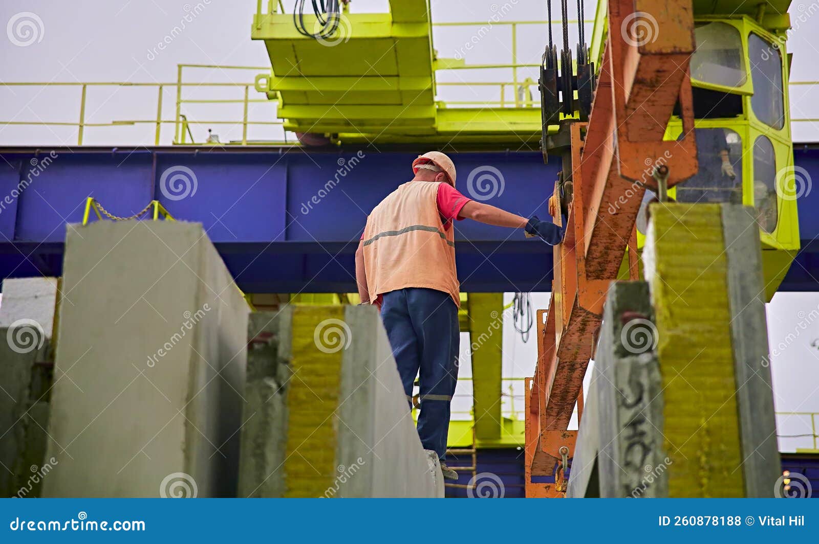 A Builder Installs a Concrete Floor Slab Panel at a Construction Site ...