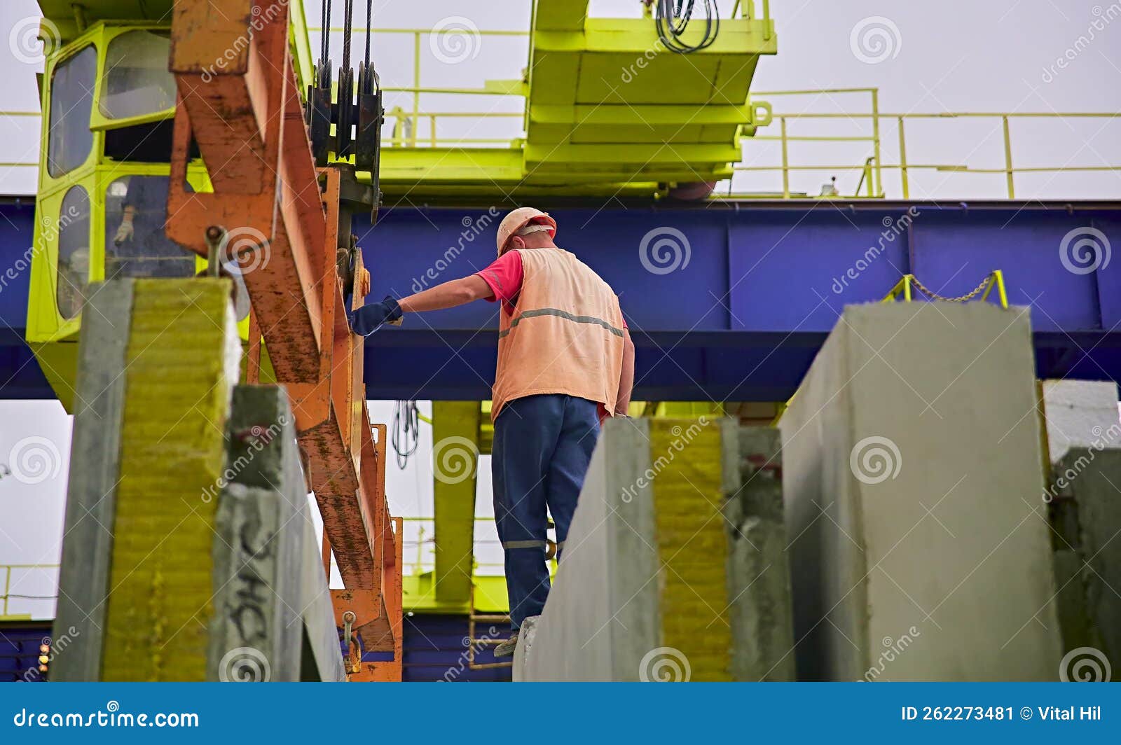 A Builder Installs a Concrete Floor Slab Panel at a Construction Site ...