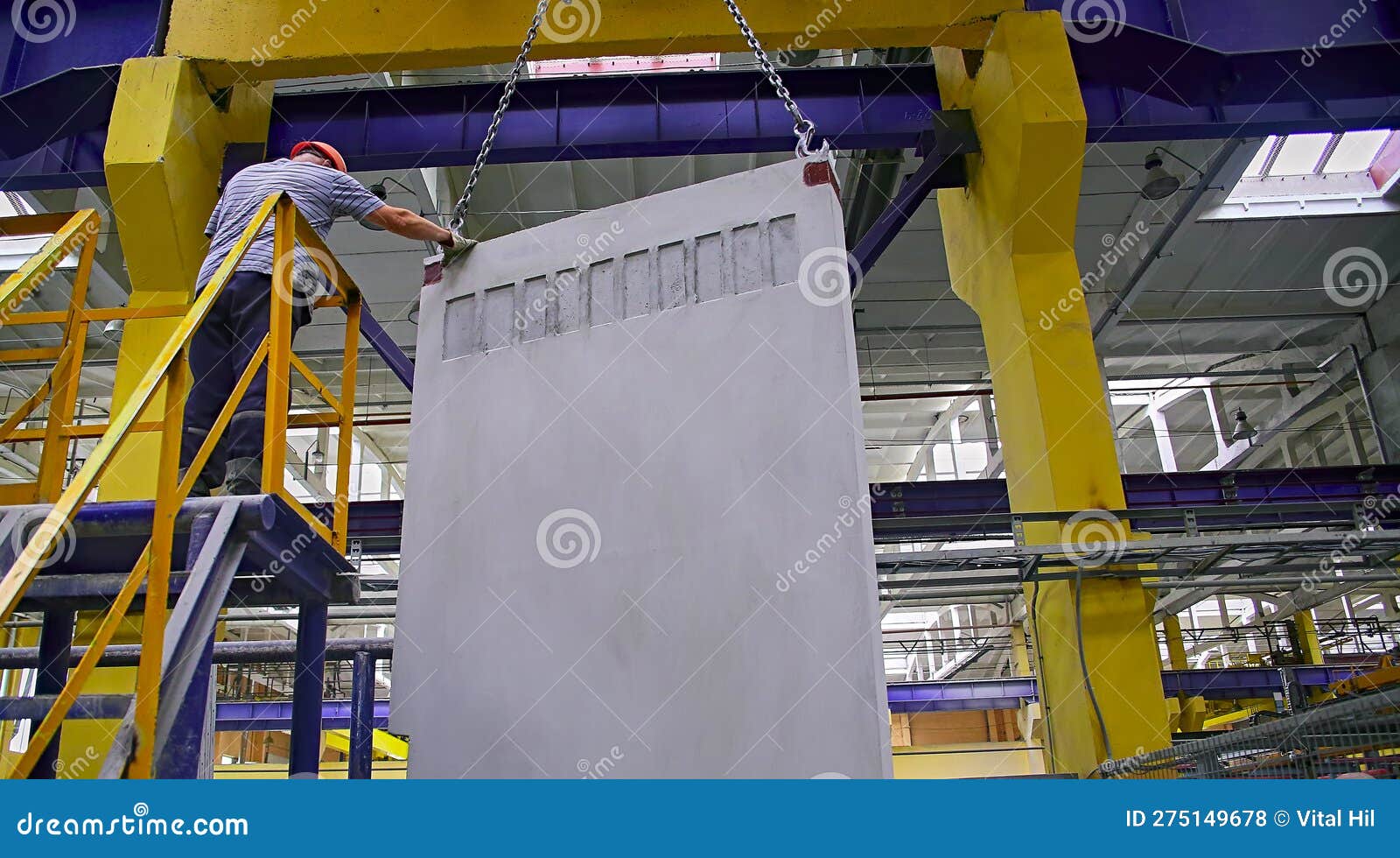 A Builder Installs a Concrete Floor Slab Panel at a Construction Site ...