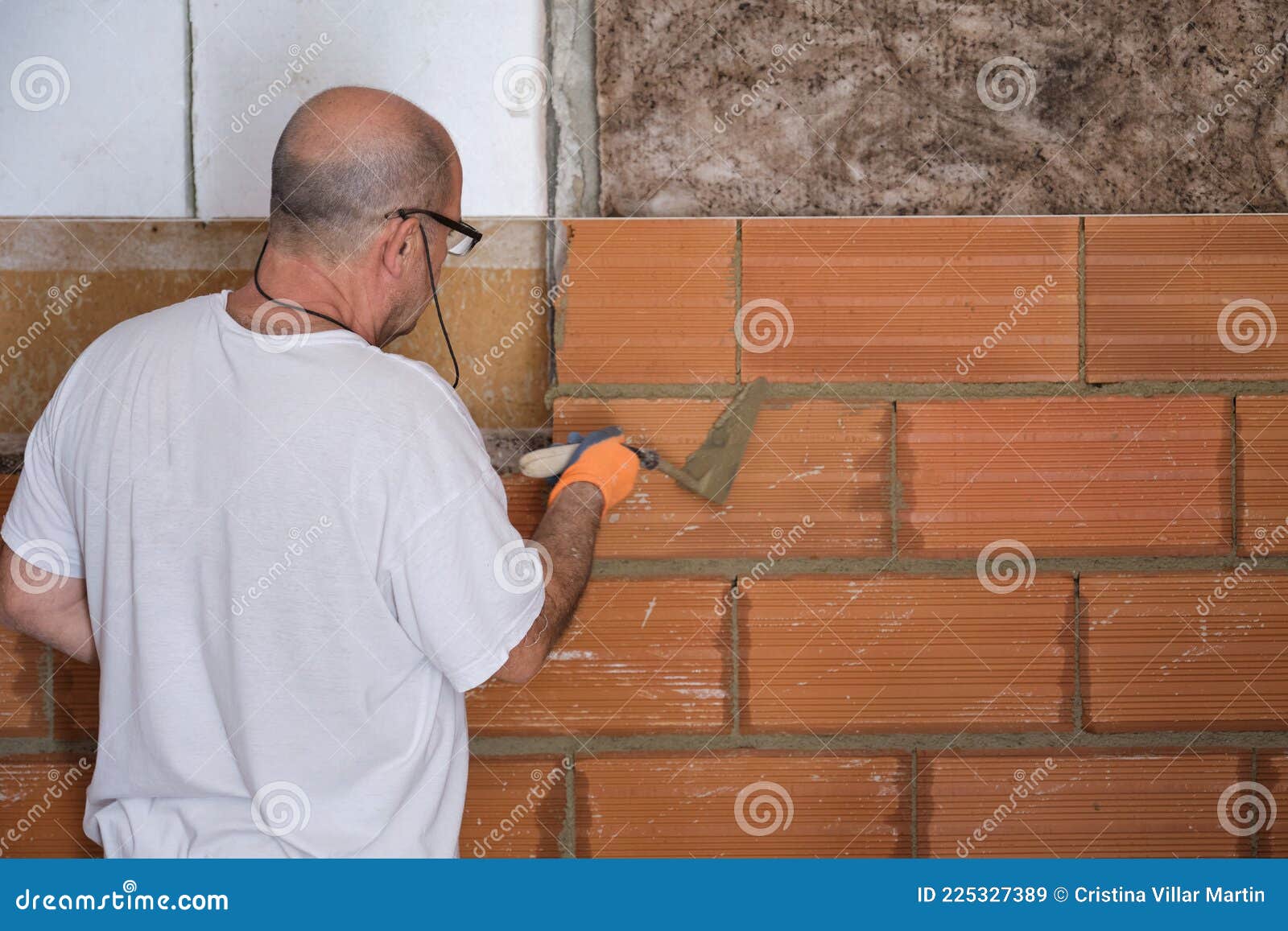 Builder Laying Bricks after Placing an Acoustic and Thermal Insulation ...