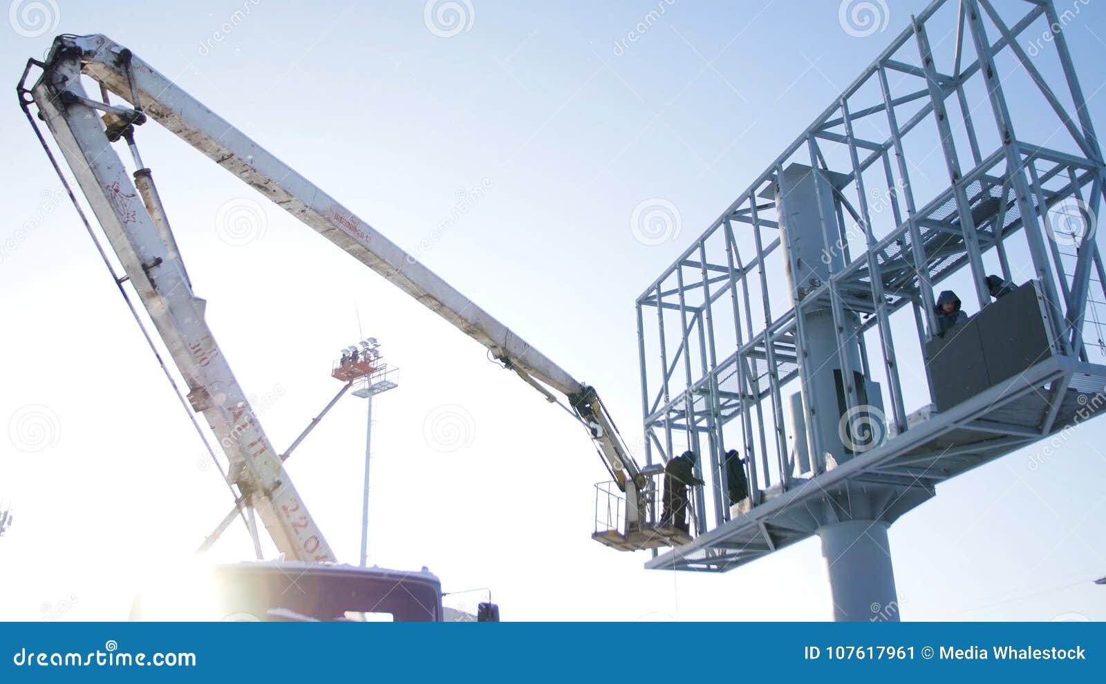 Builder on a Lift Platform at a Construction Site. Men at Work Stock ...