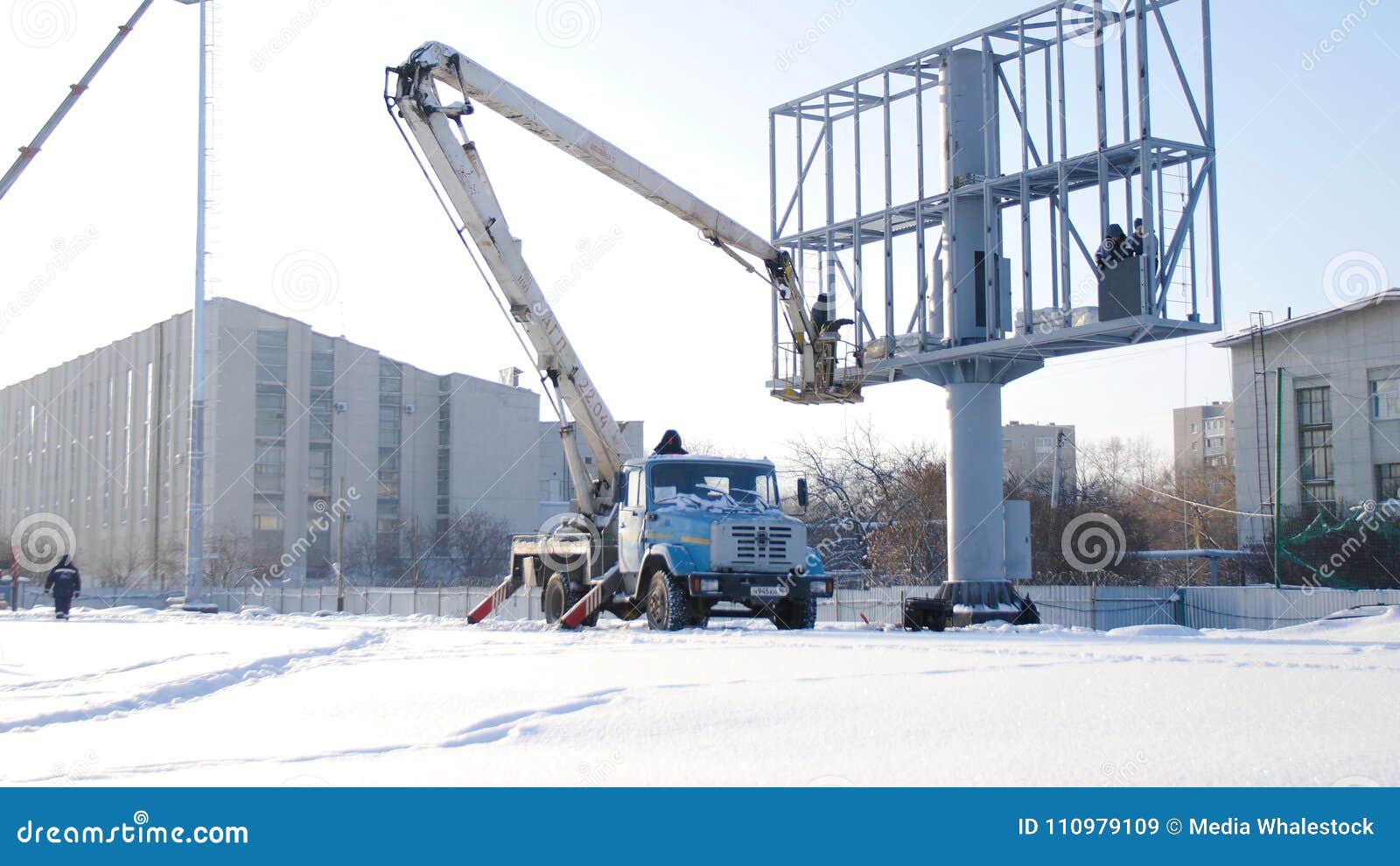 Builder on a Lift Platform at a Construction Site. Men at Work ... Builder on a Lift Platform at a Construction Site. Men at Work ...