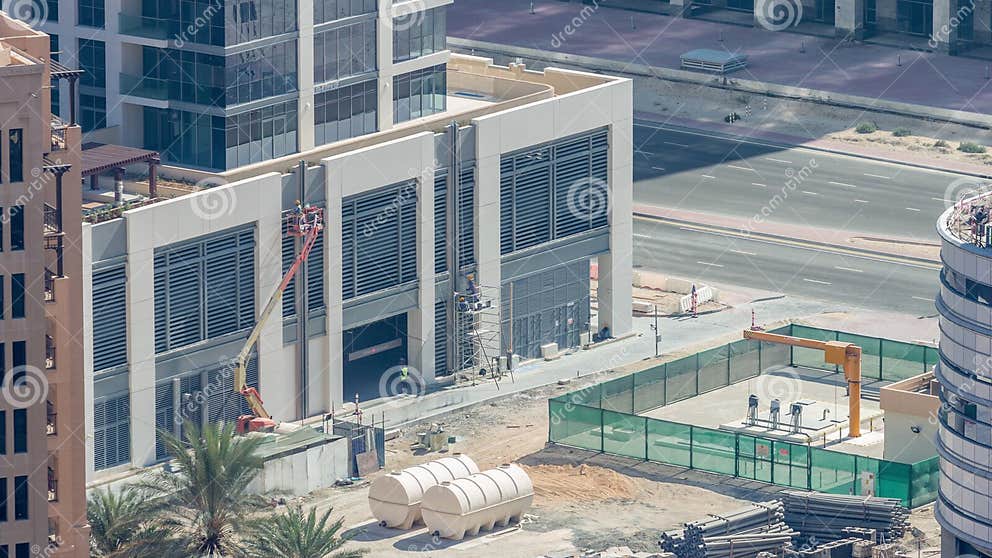 Builder on a Lift Platform on a Construction Site Timelapse. Man at ...