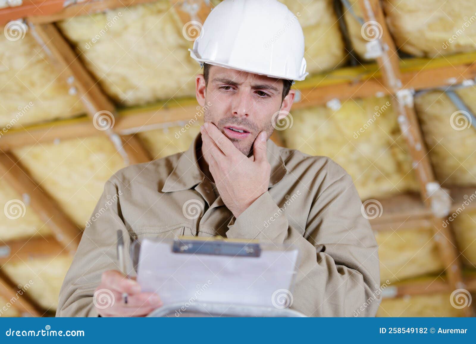 Builder Looking at Clipboard with Confusion Stock Photo - Image of ...