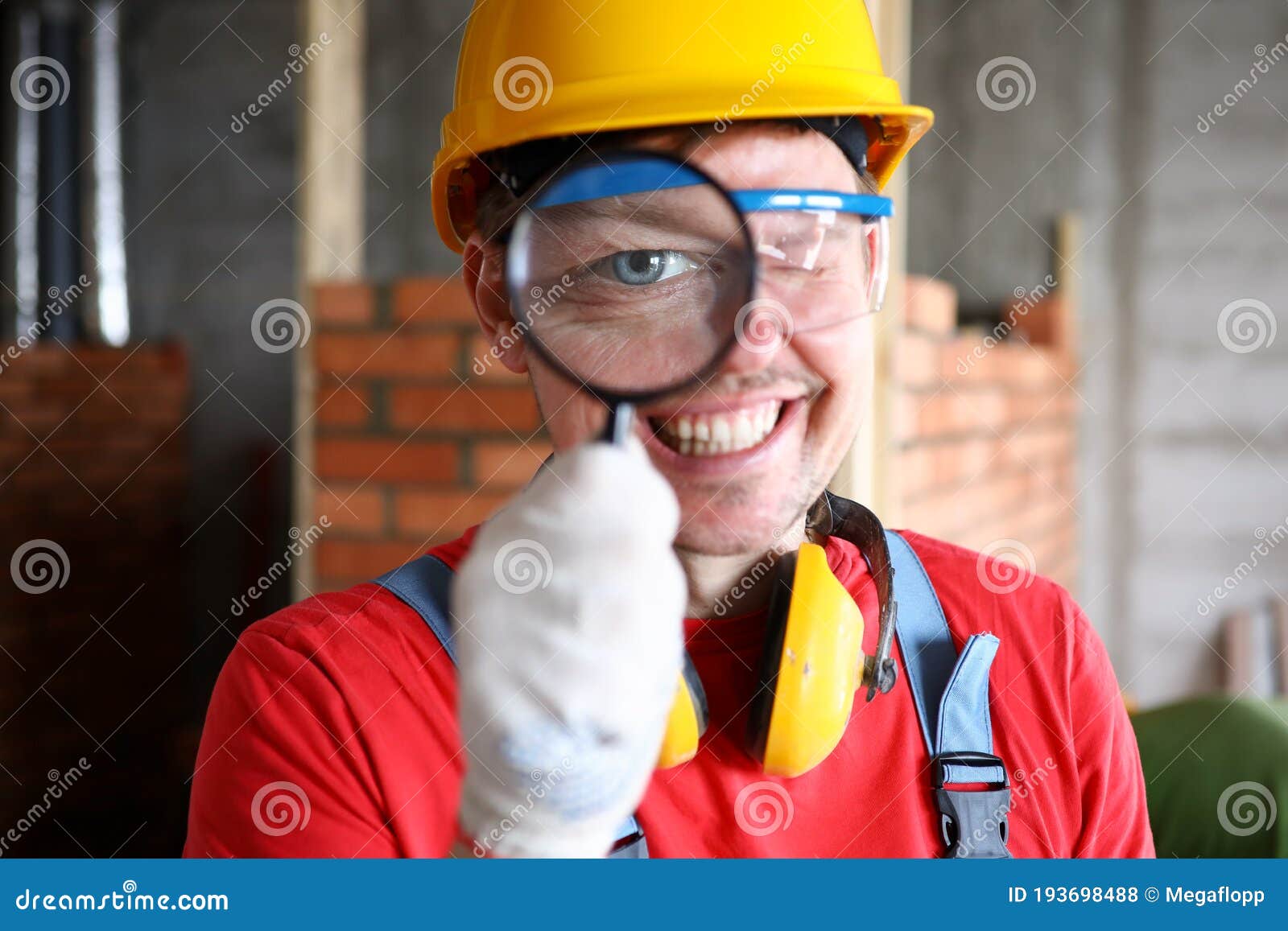 Builder Looking through Magnifying Glass, Smiling Stock Photo - Image ...