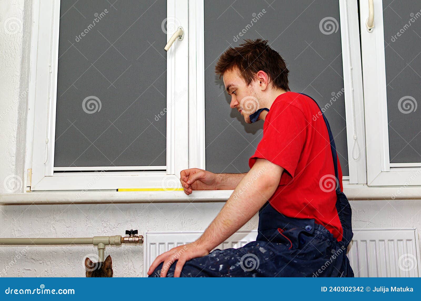 The Builder Looks at the Fresh Repair and Screwed Battery. in the Frame ...