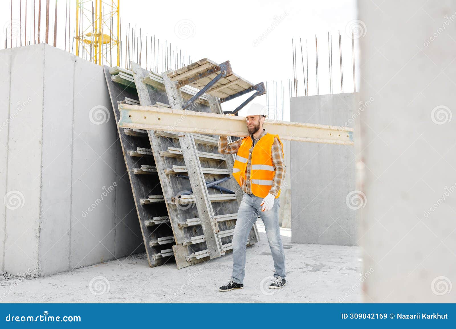 Builder Man in Hardhat and Vest Carrying Timber on Building Site in His ...