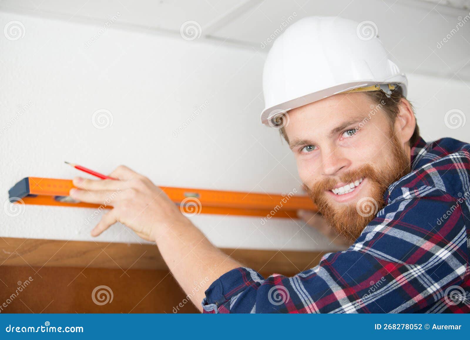 Builder Man in Uniform Standing with Spirit Level Indoors Stock Photo ...