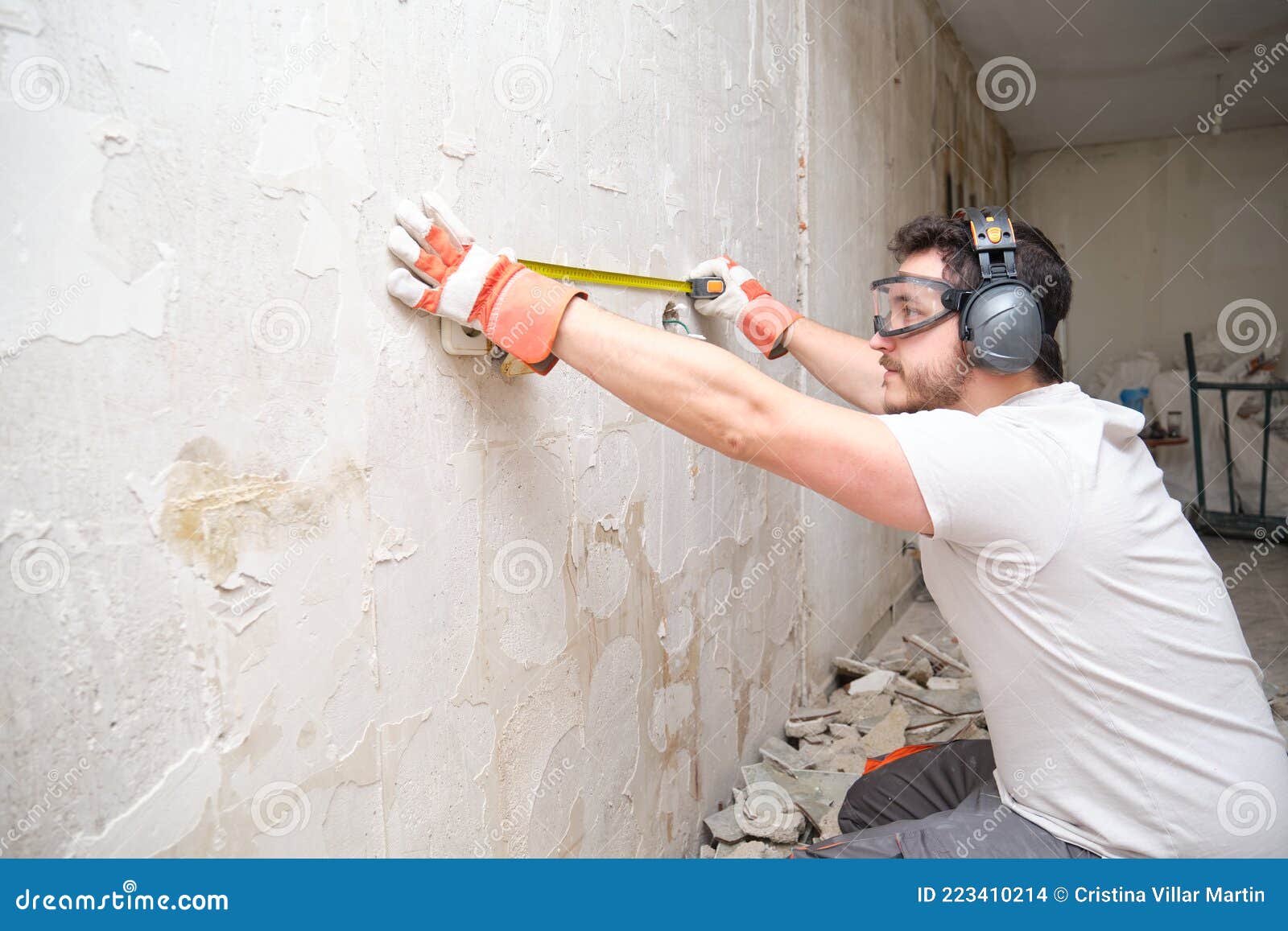 Builder Man Using a Measuring Tape at the Construction Site Stock Photo ...
