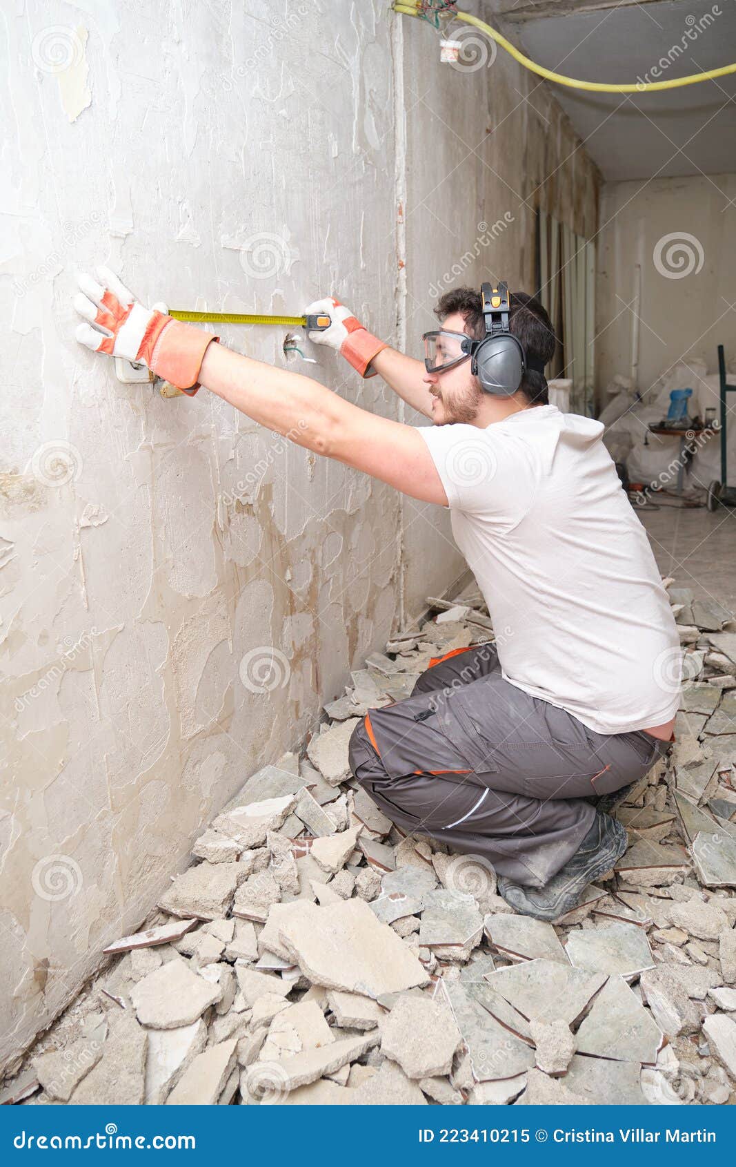 Builder Man Using a Measuring Tape at the Construction Site Stock Image ...