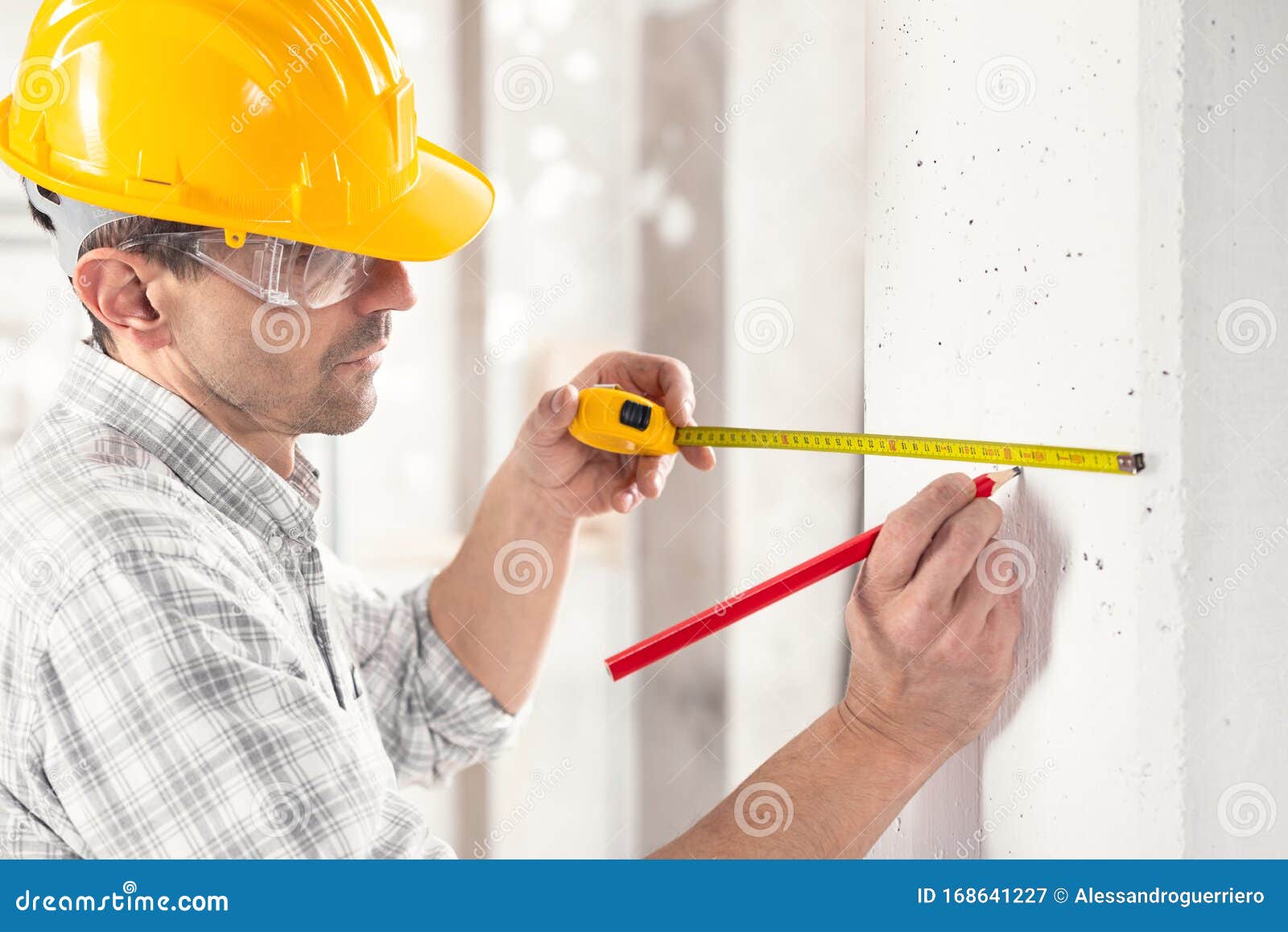 Builder Marking Measurements On A White Wall Stock Image ...
