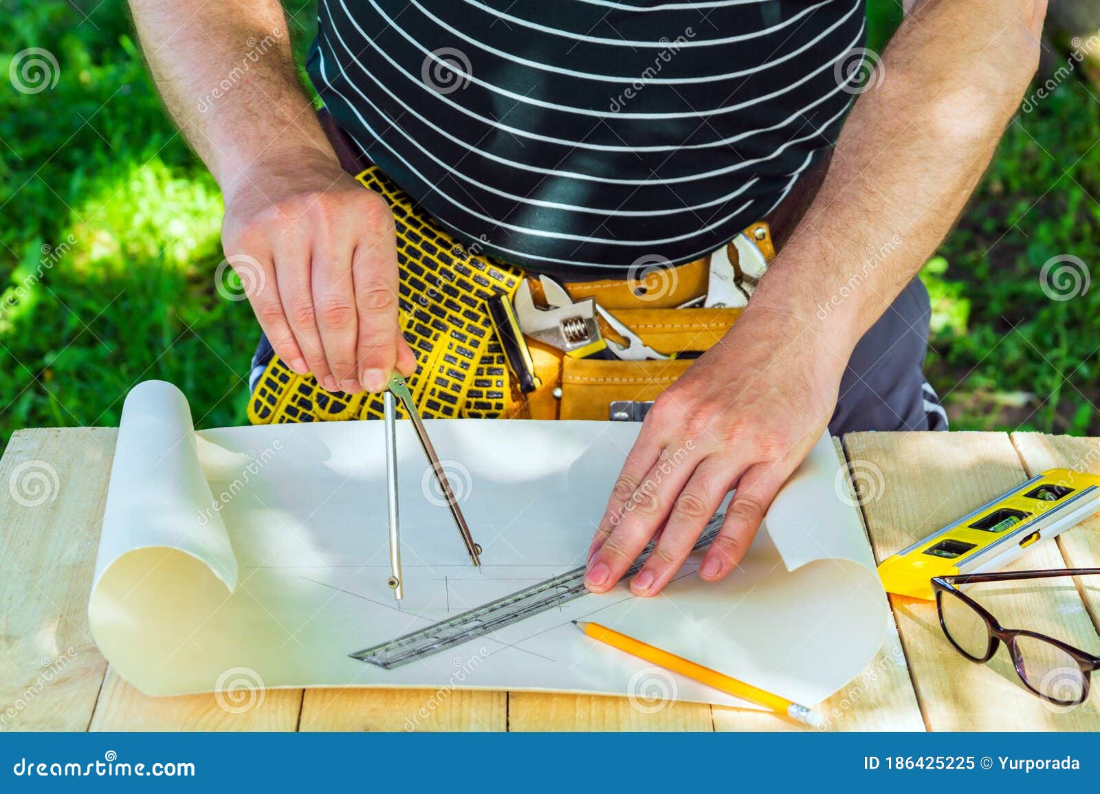 Builder Master Measures the Distance in the Drawing Using a Compass ...