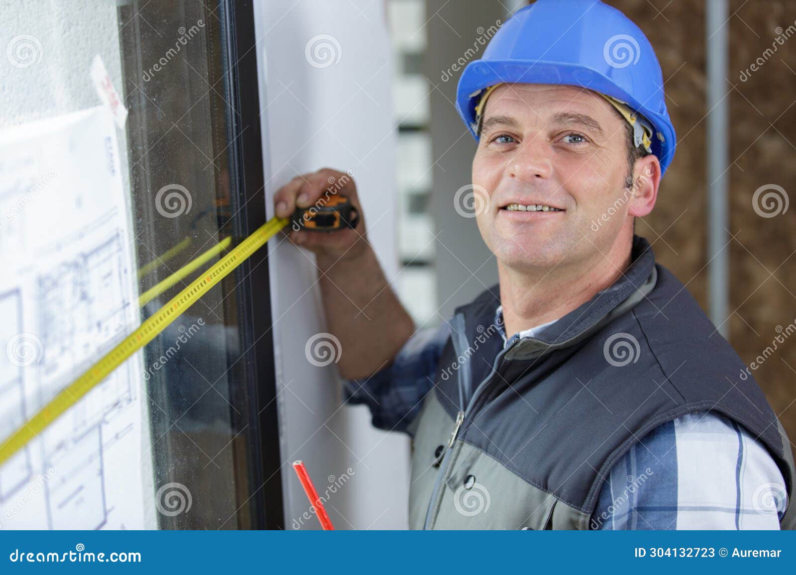 Builder Measuring Window Using Measure Tape at Construction Site Stock ...