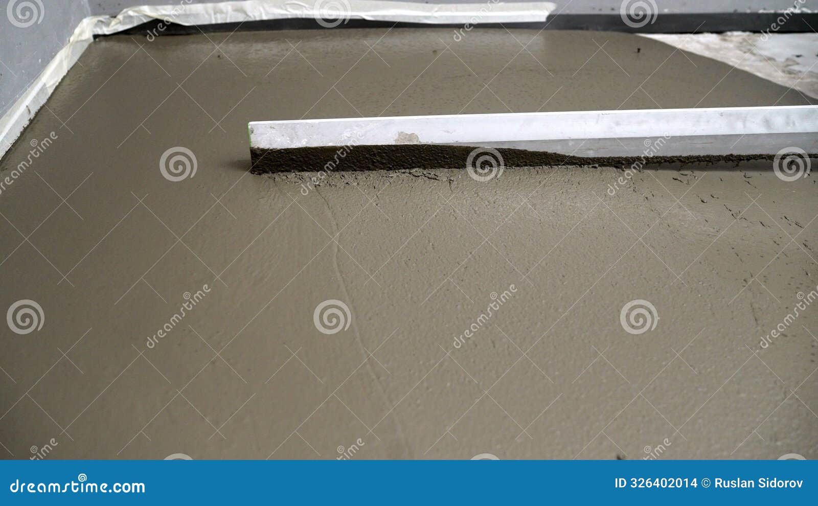 A Builder Mixes Mortar in a Bucket Using a Manual Concrete Mixer. the ...