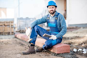 Builder Mounting Road Borders Stock Photo - Image of laying, blue ...