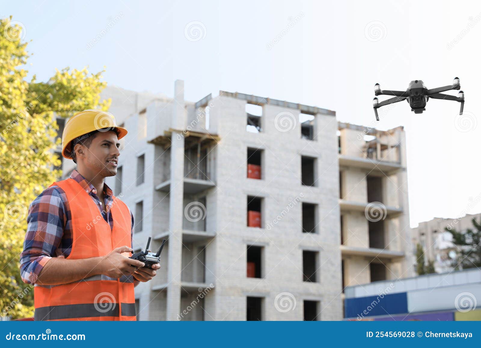 Builder Operating Drone with Remote Control at Construction Site ...