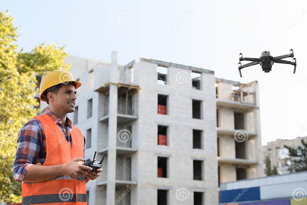 Builder Operating Drone with Remote Control at Construction Site ...