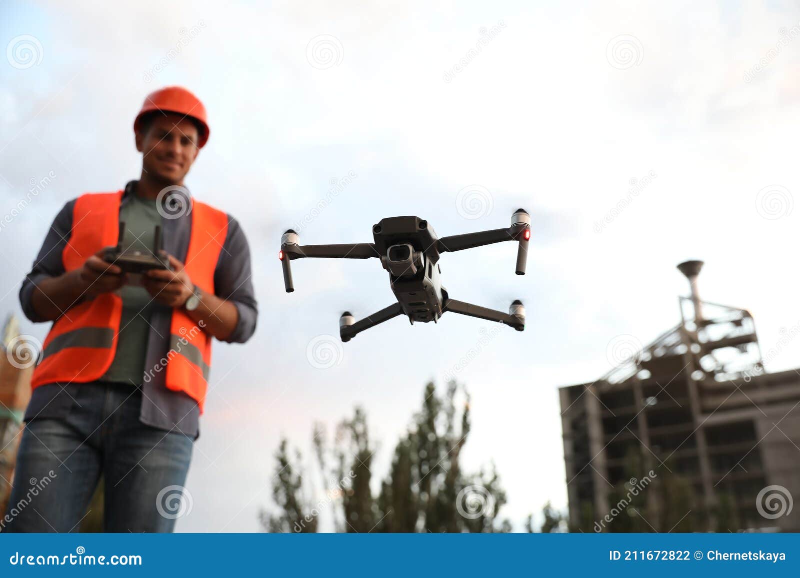Builder Operating Drone with Remote Control at Construction Site ...