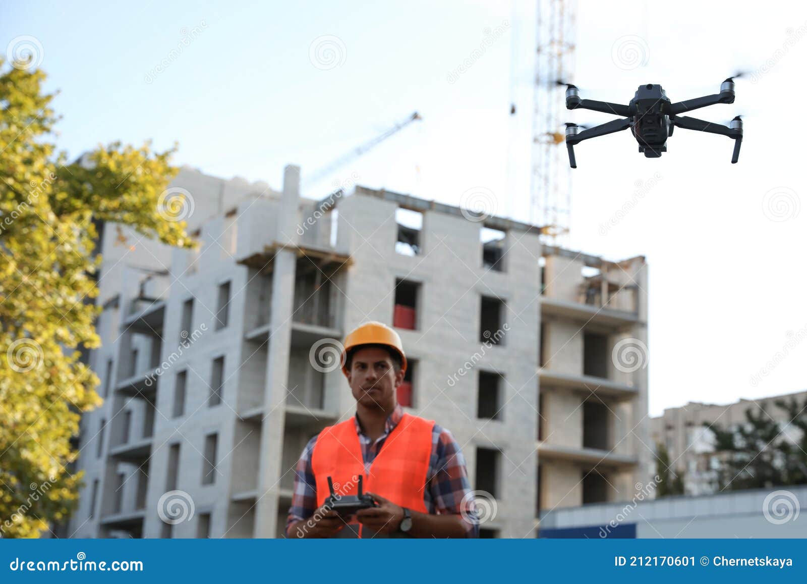 Builder Operating Drone with Remote Control at Construction Site ...