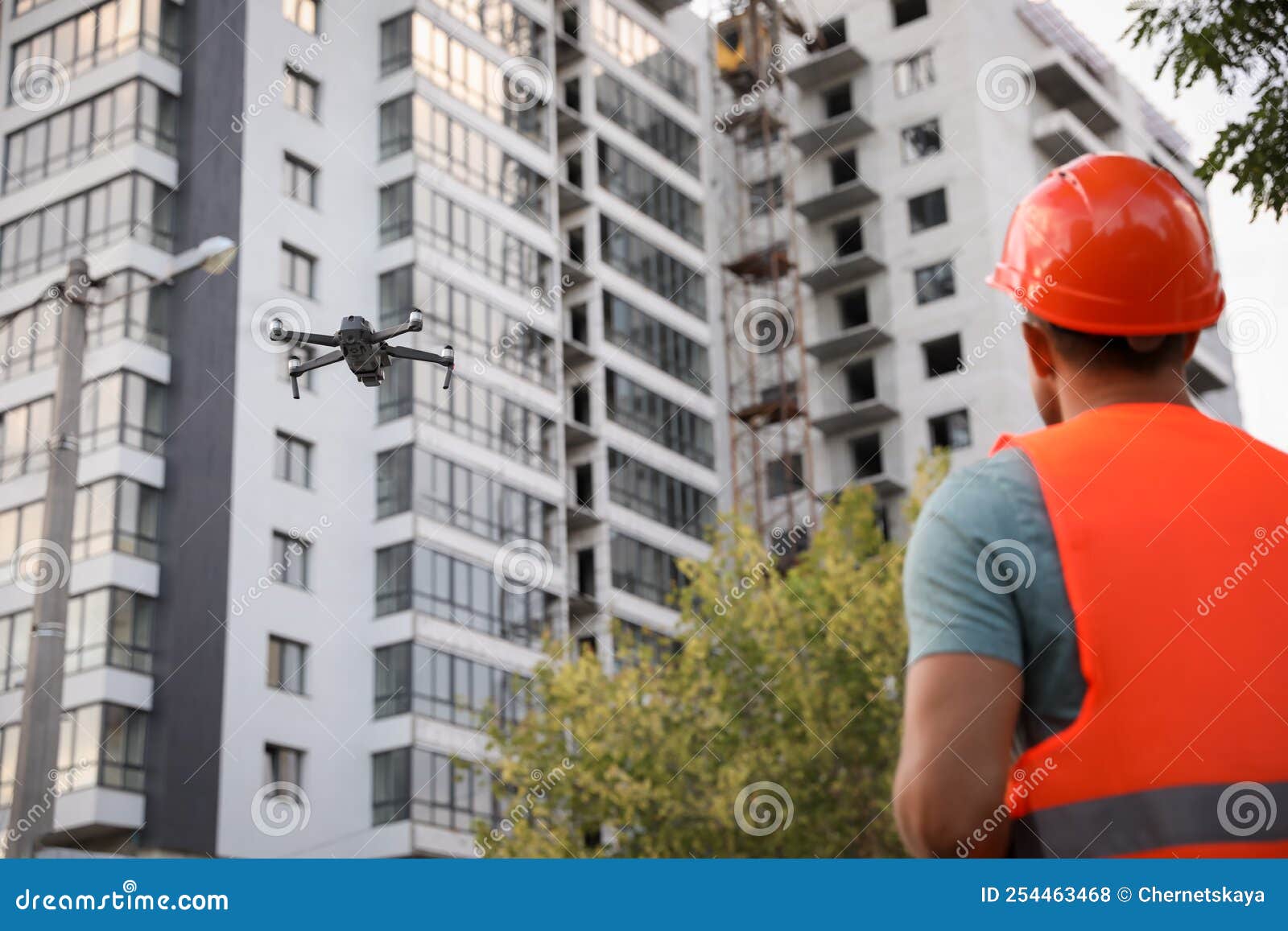 Builder Operating Drone with Remote Control at Construction Site ...
