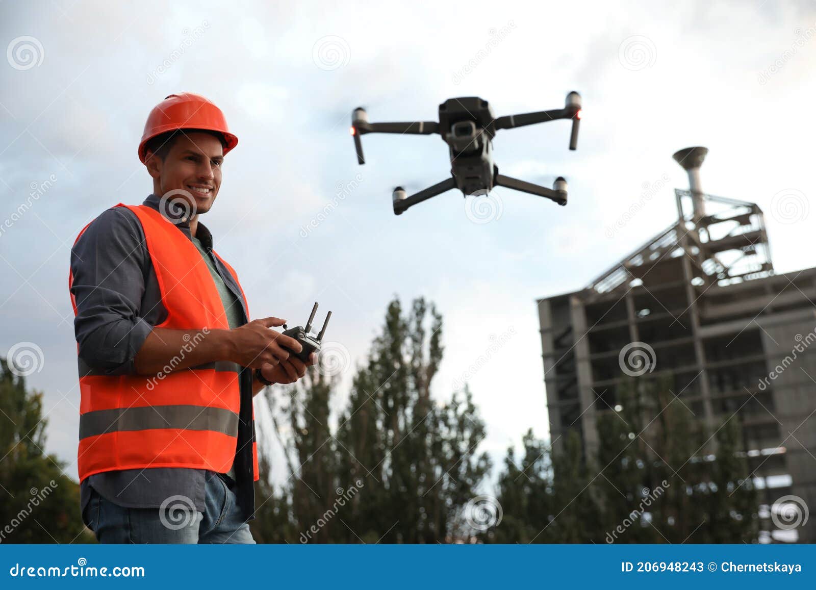 Builder Operating Drone with Remote Control at Construction Site ...