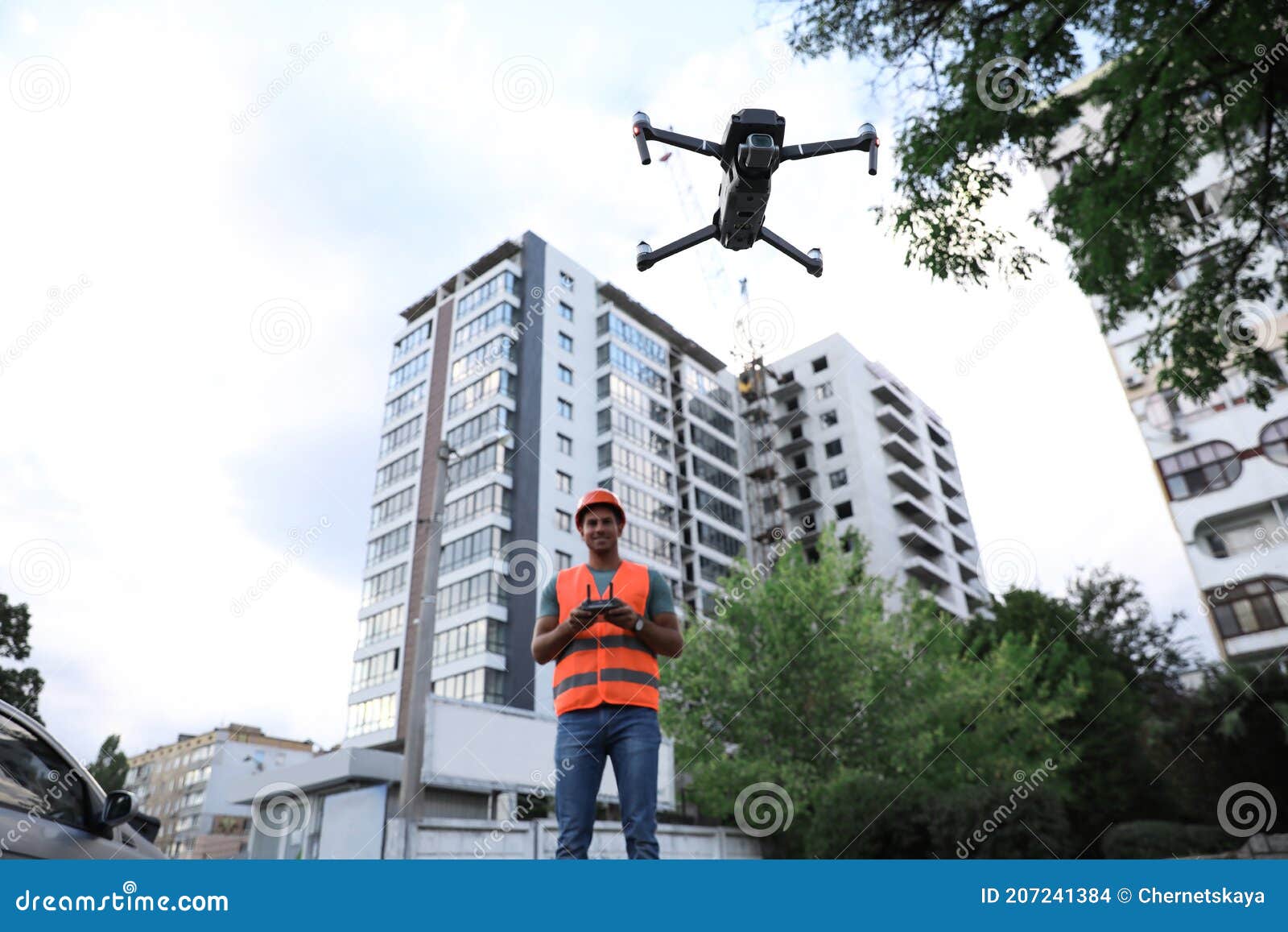 Builder Operating Drone with Remote Control at Construction Site ...