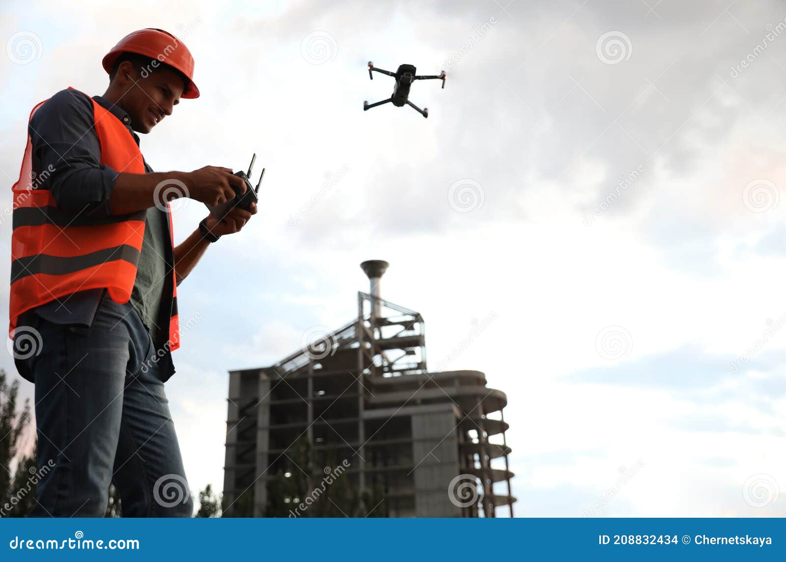 Builder Operating Drone with Remote Control at Construction Site ...