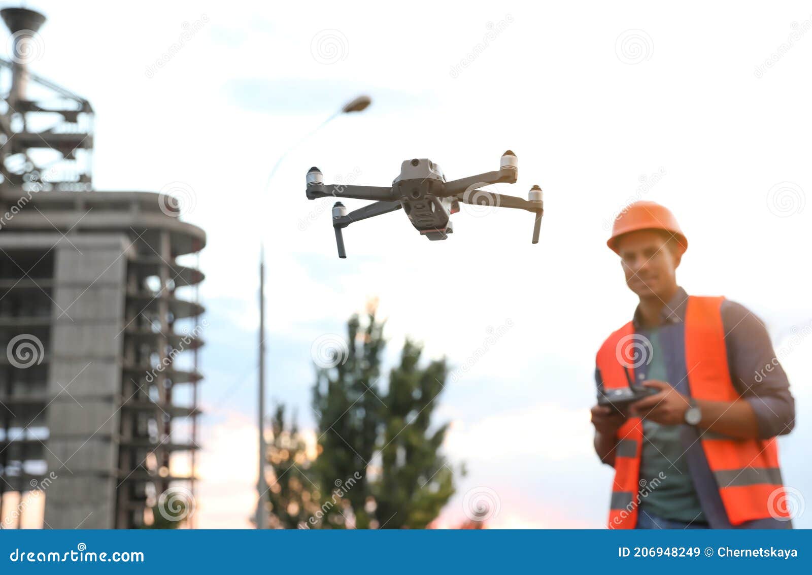 Builder Operating Drone with Remote Control at Construction Site, Focus ...