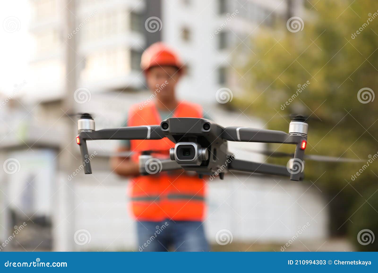 Builder Operating Drone with Remote Control at Construction Site, Focus ...