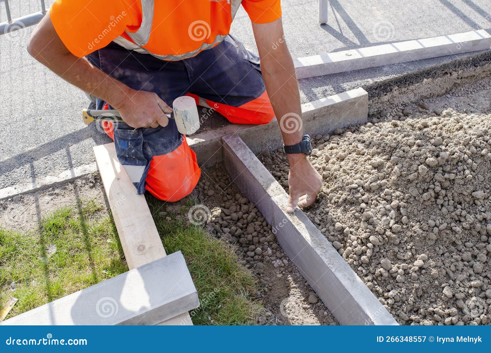 Builder in Orange Ho-viz Protective Closing Placing Edging Pin Kerb ...