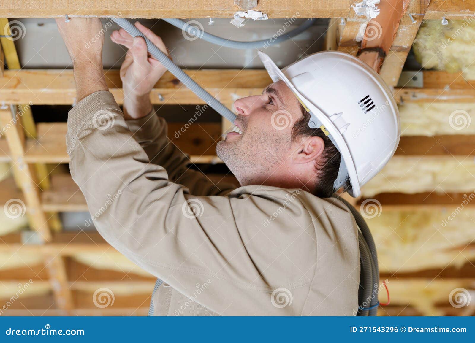 Builder Passing Cables through Ceiling Joists Stock Photo - Image of ...