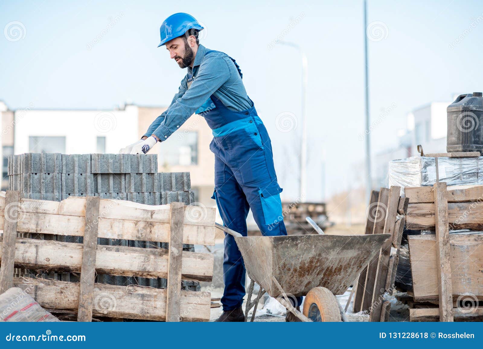 Builder with Paving Tiles on the Construction Site Stock Photo - Image ...