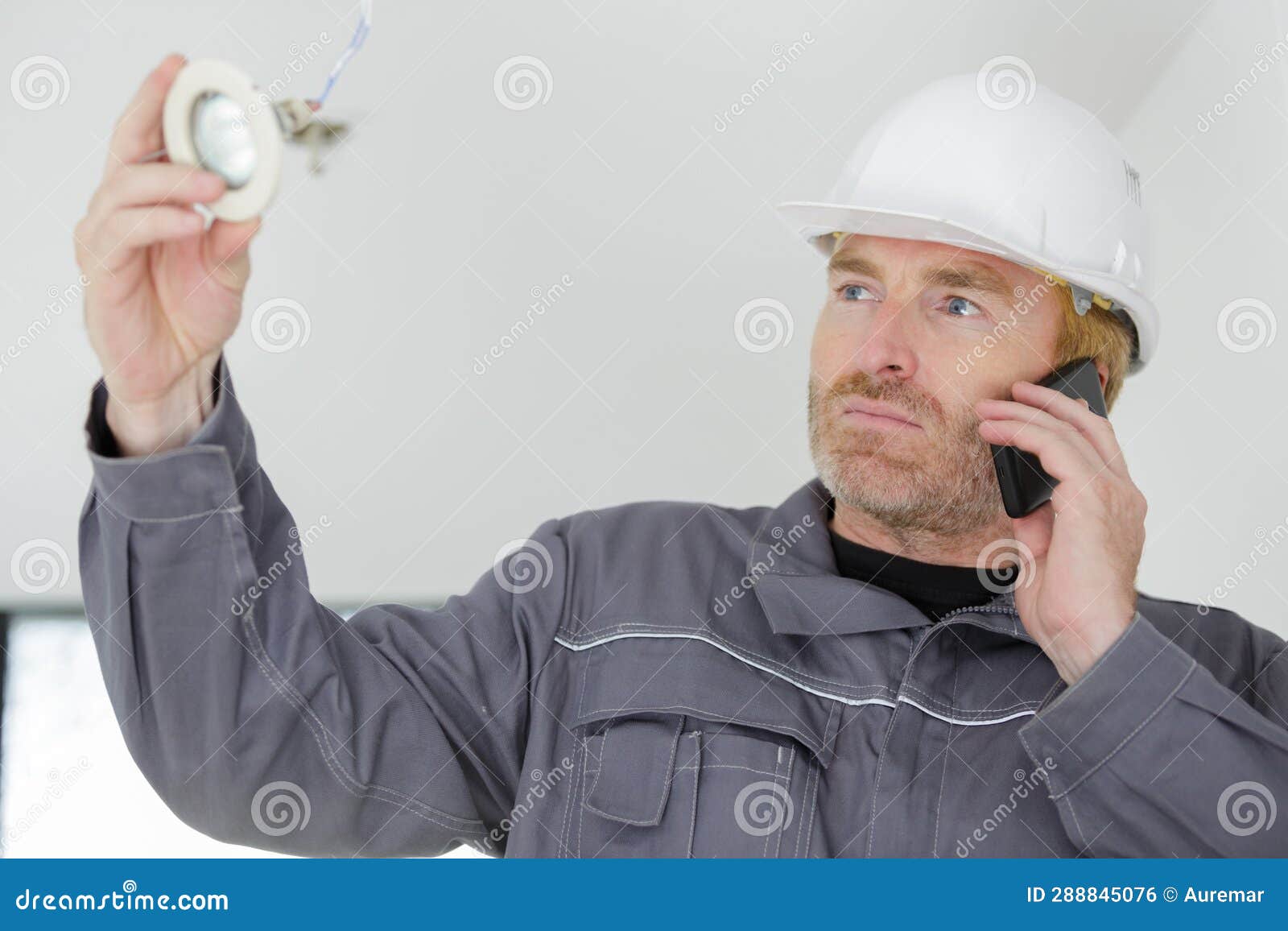 Builder on Phone Installing Spotlight in Room Stock Photo - Image of ...