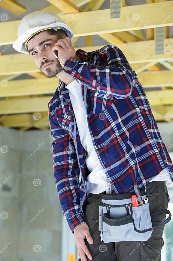 Builder on phone by ladder stock photo. Image of handyman - 309079924