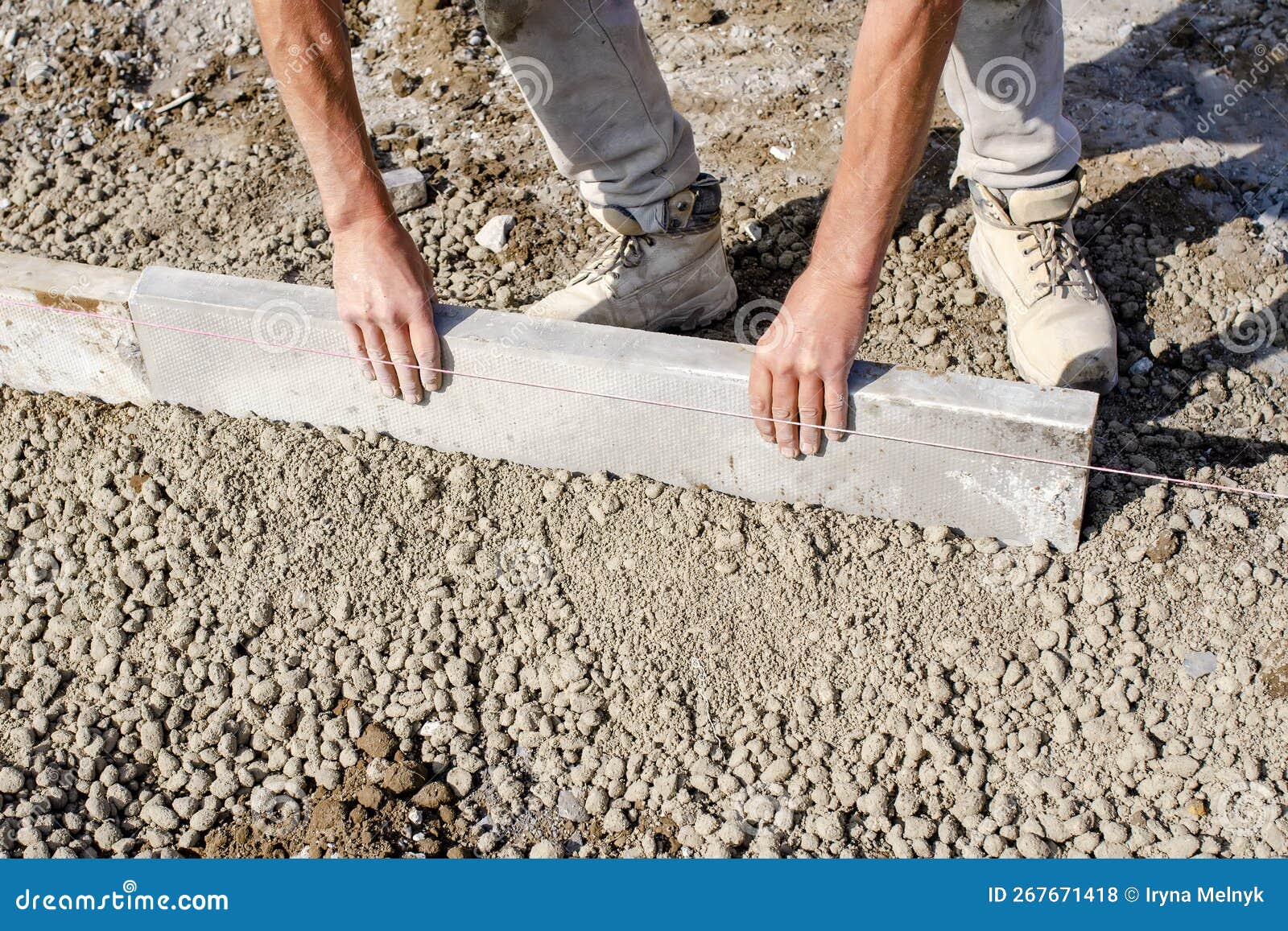 Builder Placing Edging Pin Kerb on Semi-dry Concrete Using a String ...