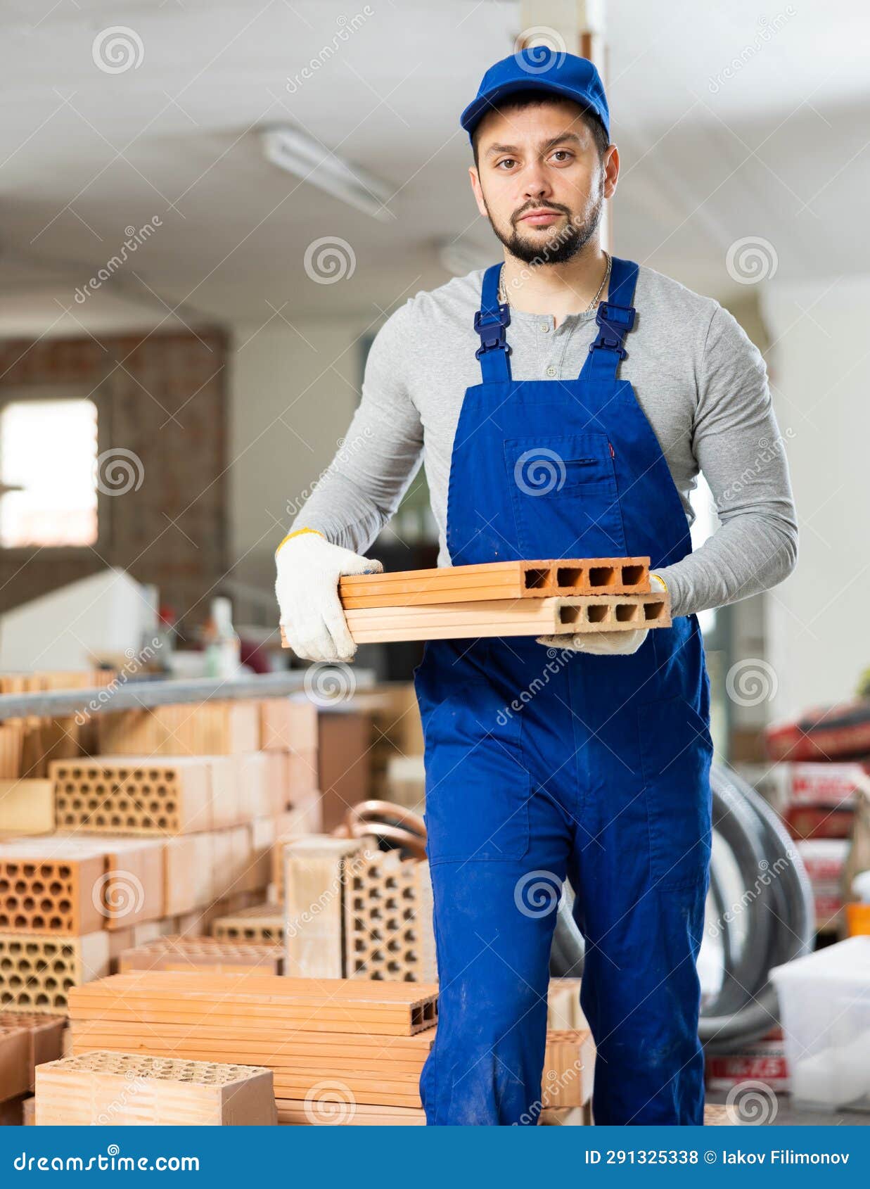 Builder Preparing Bricks for Work in Building Under Reconstruction ...
