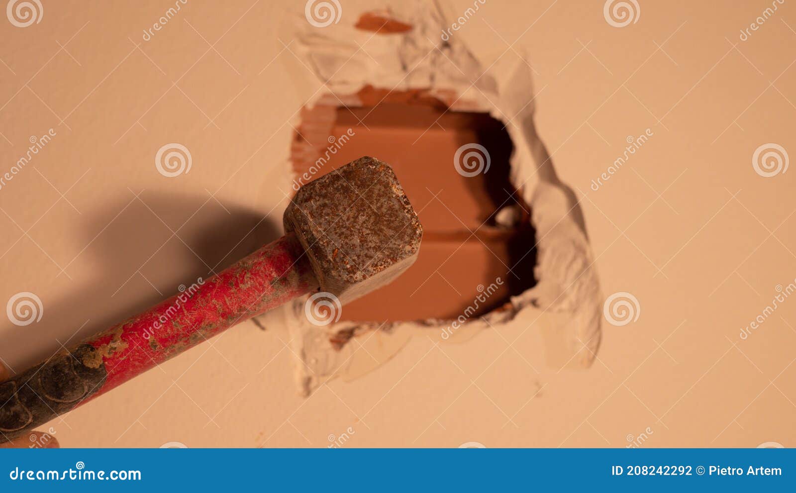 Builder Punches a Hole in the Wall with a Hammer, Close Up Stock Photo ...