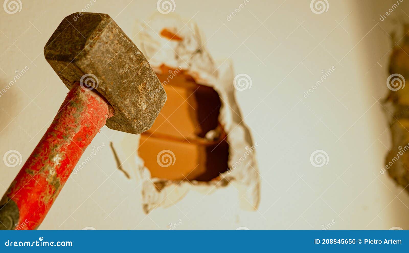 Builder Punches a Hole in the Wall with a Hammer, Close Up Stock Photo ...