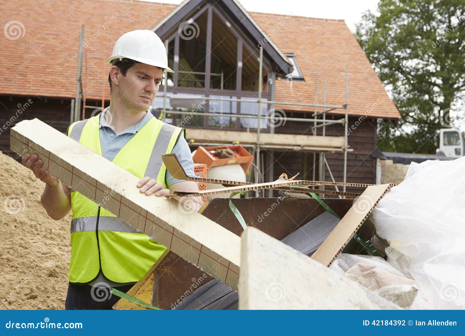 Builder Putting Waste into Rubbish Skip Stock Photo - Image of jacket ...