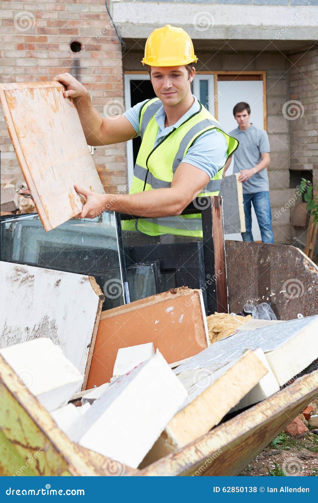 Builder Putting Waste into Rubbish Skip Stock Photo - Image of ...
