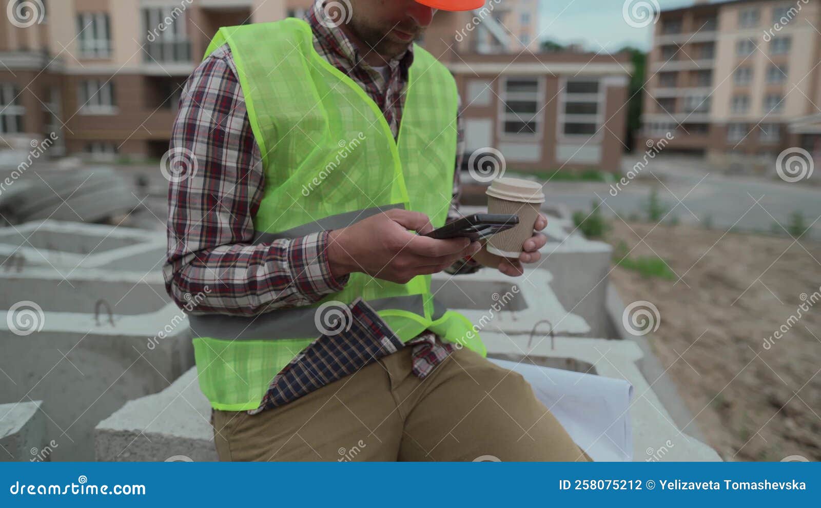 Builder Relaxes Sitting on Construction Elements at Worksite, Drinking ...