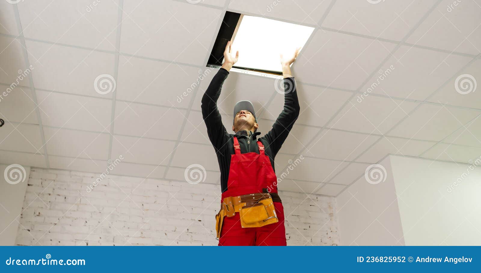 A Builder Replacing Ceiling Panel, Working, Armstrong. Stock Photo ...