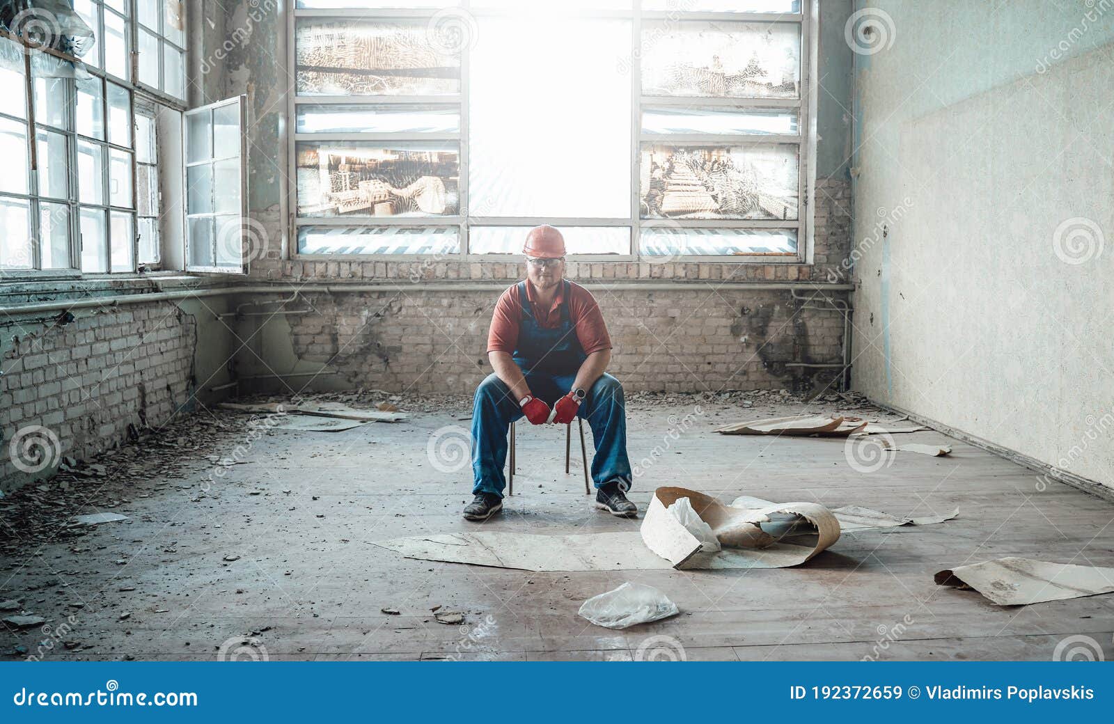 Worker Sitting on a Chair in the Middle of a Construction Site Stock ...