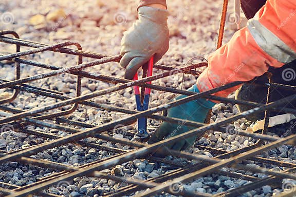 Builder`s Hands Fixing Steel Reinforcement Bars at Construction Site ...