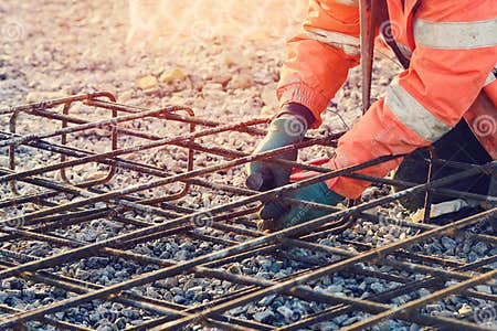 Builder`s Hands Fixing Steel Reinforcement Bars at Construction Site ...