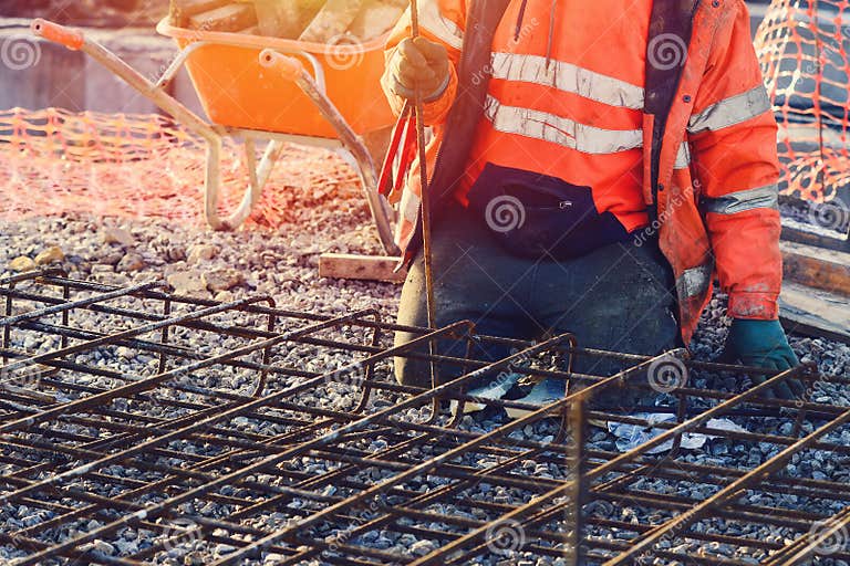 Builder Hands Fixing Steel Reinforcement Bars at Construction Site ...